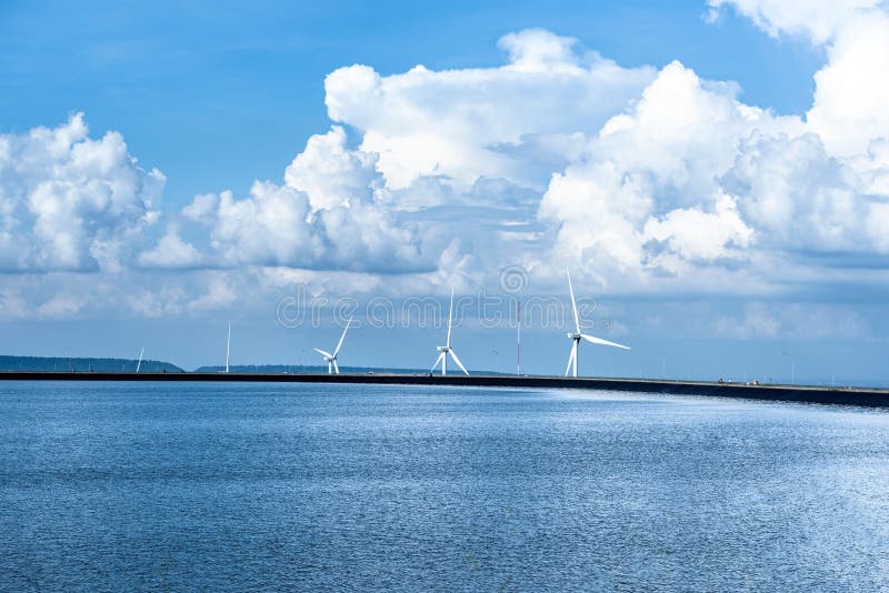Scenic Landscape of Wind Turbines in a Lake Against a Backdrop of White ...