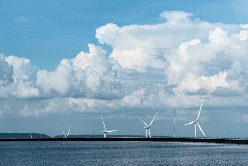 Scenic Landscape of Wind Turbines in a Lake Against a Backdrop of White ...