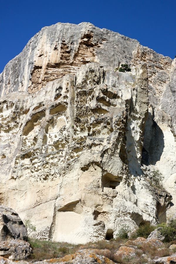 Scenic Limestone Cliff with Caves with Azure Sky Background in Crimea ...