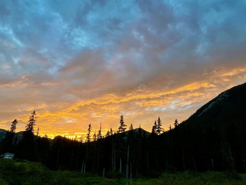Scenic Low Angle Shot of a Mountain Range on a Grass Field during ...