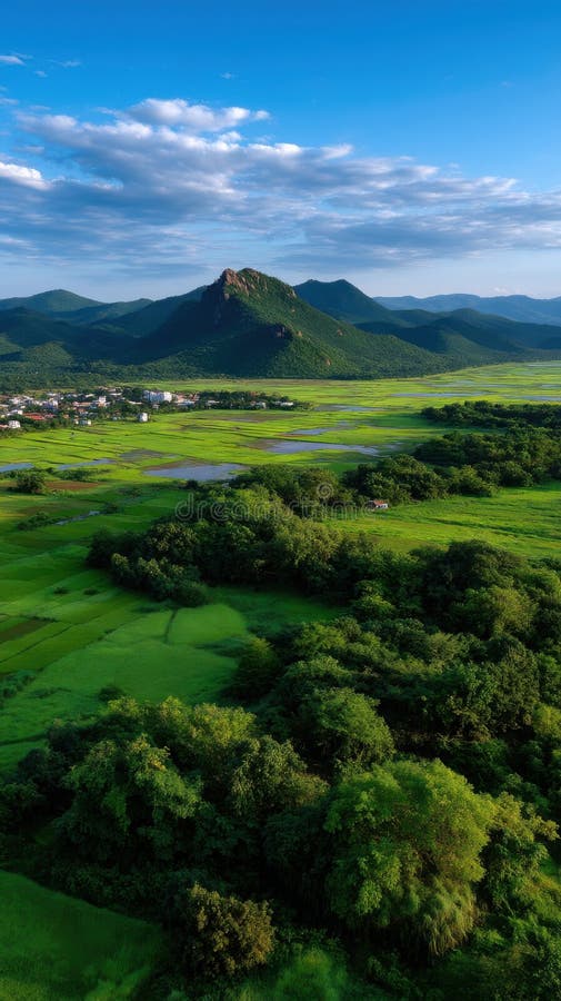Scenic Mountain Landscape with Lush Green Fields and Blue Sky Stock ...