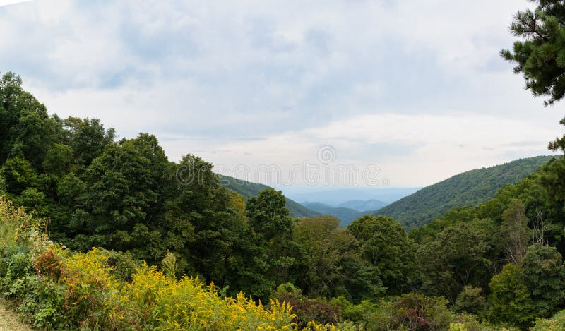 Scenic Panorama Down a Valley with Distant Mountain Range, Overcast Sky ...