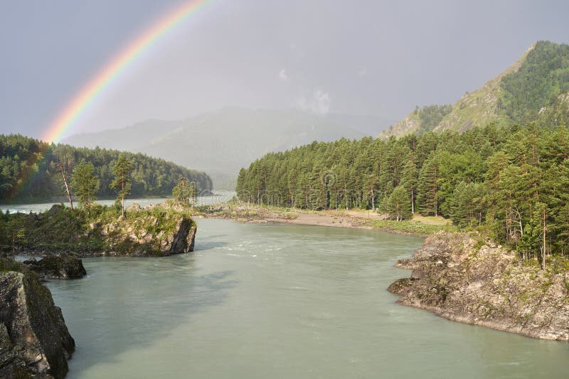 Scenic River with Rainbow and Forested Mountains Under a Clear Sky Stock Photo - Image of ...