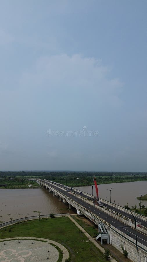 Scenic River View with Bridge and Greenery Stock Image - Image of water ...