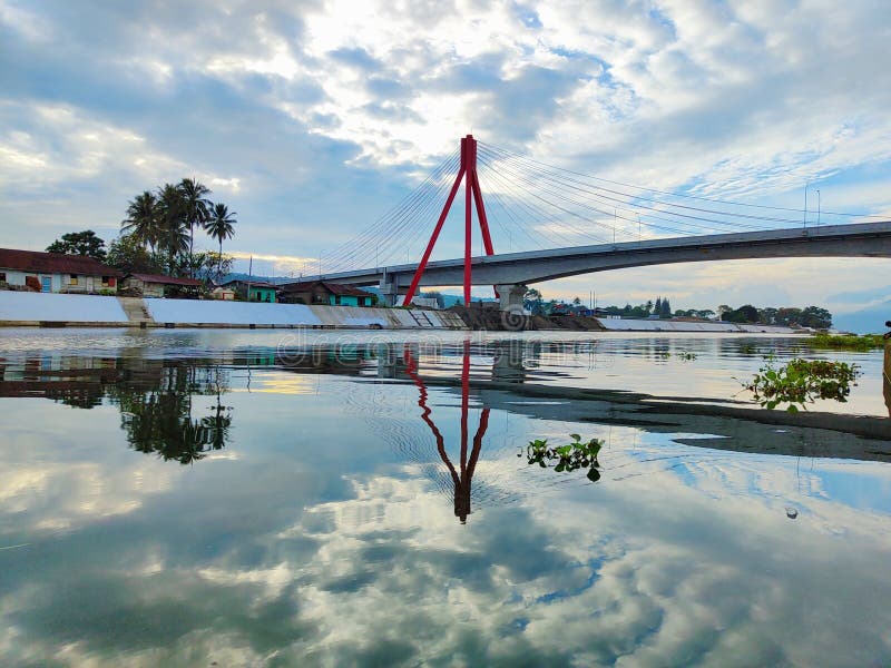 Scenic River View with Reflective Calm Water Under Modern Bridge Stock ...