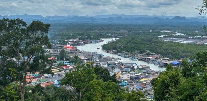 Scenic Riverside Town with Mountain Backdrop Stock Photo - Image of ...
