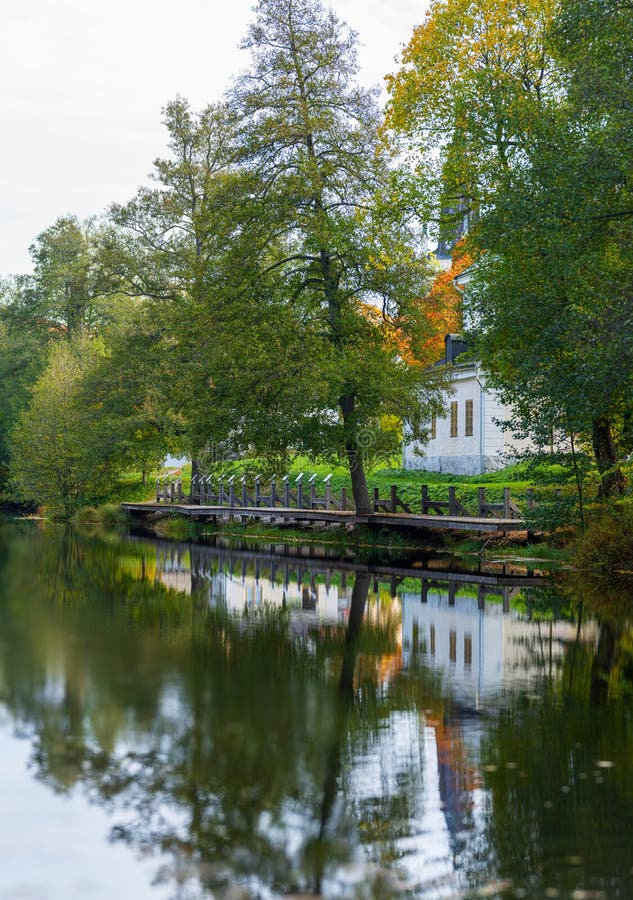 Scenic Riverside with Trees and Wooden Walkway.. Stock Image - Image of ...