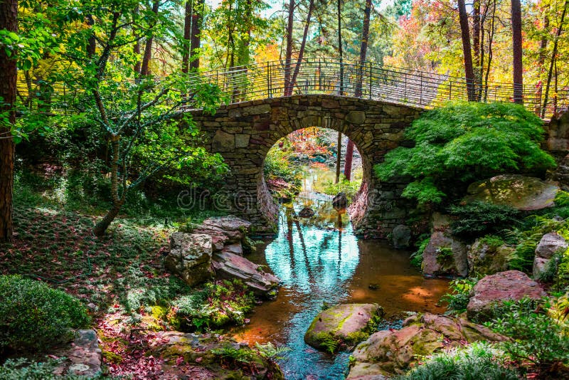 Scenic Round Stone Bridge Over a Stream with Fall Colors Emerging Stock ...