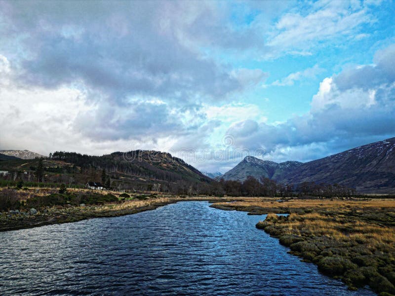 Scenic Shot of a River Flowing through the Scottish Highlands Under the ...
