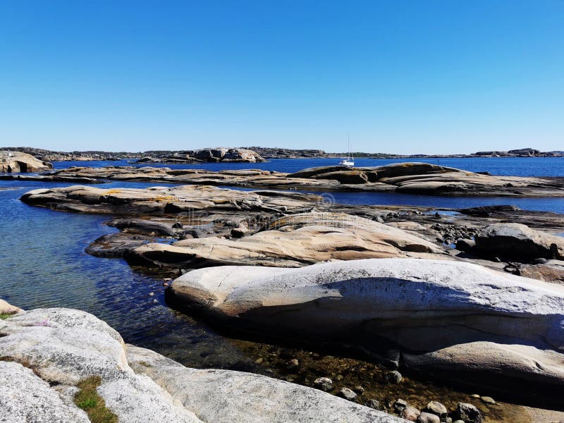 Scenic Shot of a Sea Surrounded by Stone Mountains in Verdens Ende ... Scenic Shot of a Sea Surrounded by Stone Mountains in Verdens Ende ...