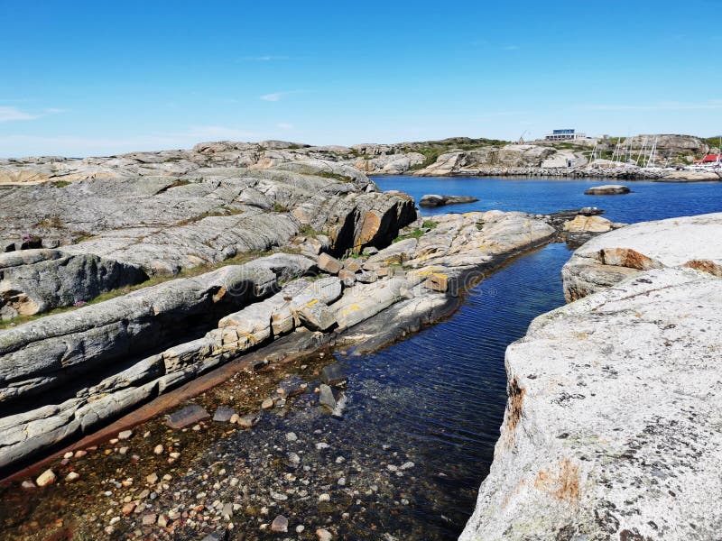 Scenic Shot of a Sea Surrounded by Stone Mountains in Verdens Ende ... Scenic Shot of a Sea Surrounded by Stone Mountains in Verdens Ende ...