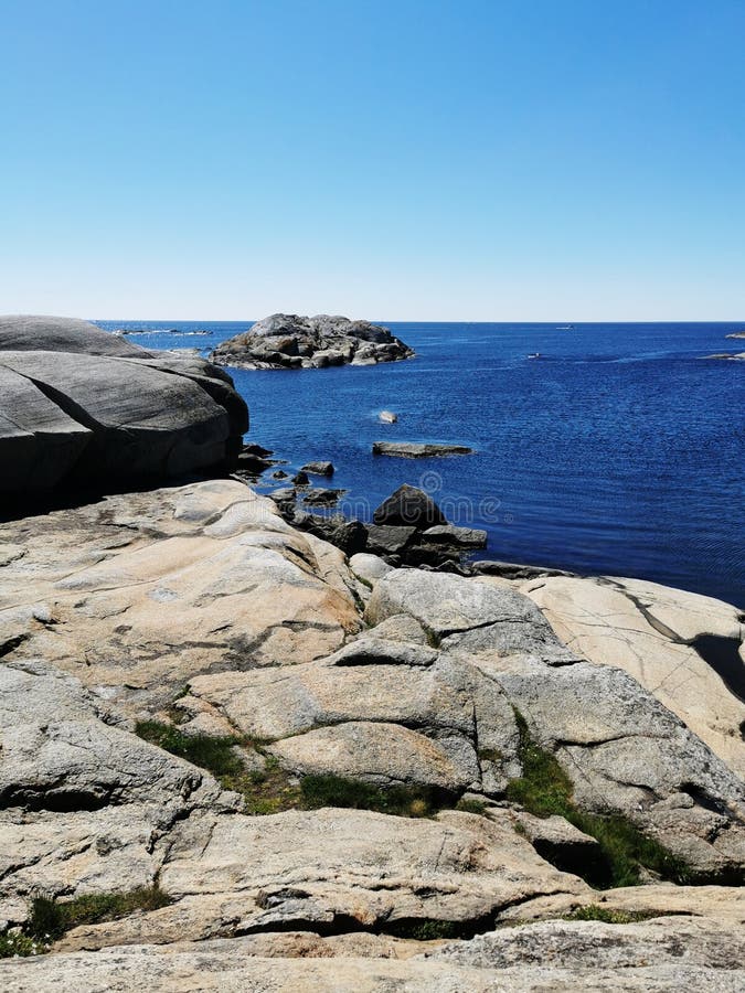 Scenic Shot of a Sea Surrounded by Stone Mountains in Verdens Ende ... Scenic Shot of a Sea Surrounded by Stone Mountains in Verdens Ende ...