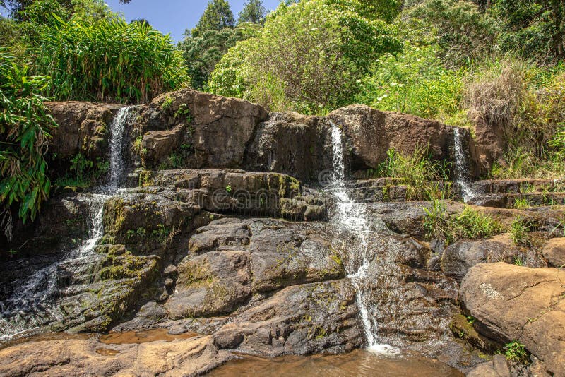 Scenic Shot of Small Waterfalls Flowing from Rocks in a Park Stock ...