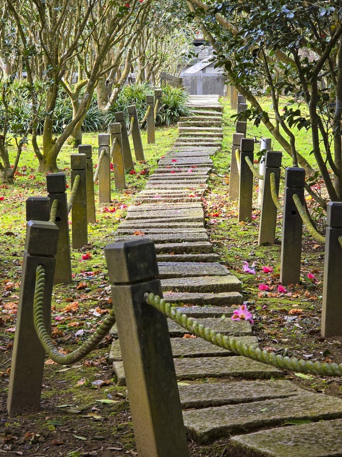 Scenic Stone-Paved Pathway in the Park with Wooden Posts and Ropes ...