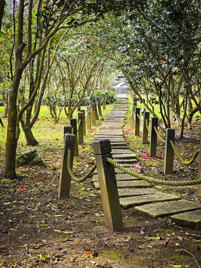 Scenic Stone-Paved Pathway in the Park with Wooden Posts and Ropes ...
