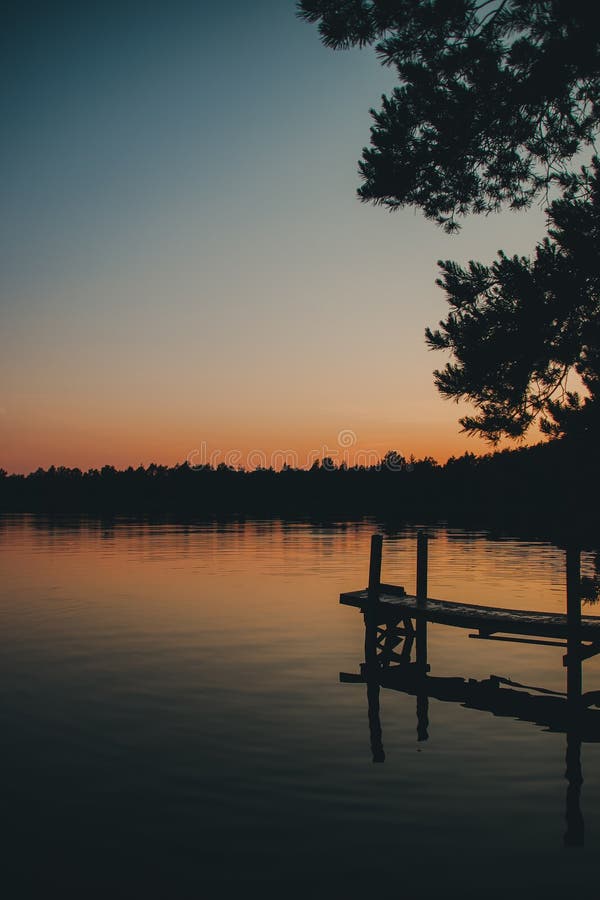 Scenic Sunset at an Aged Dock by the Lake with at Night Stock Photo ...