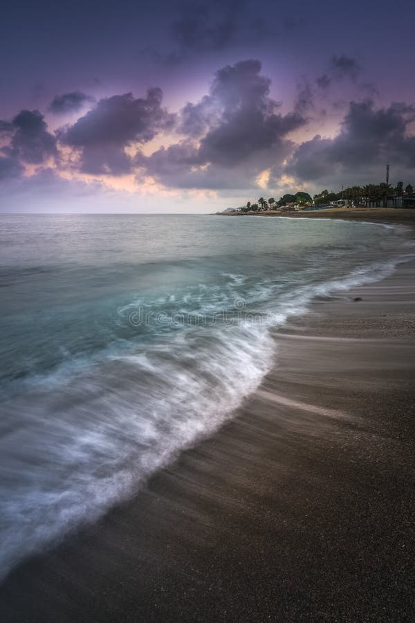 Scenic Vertical Shot of a Seashore during Twilight with the Waves ...