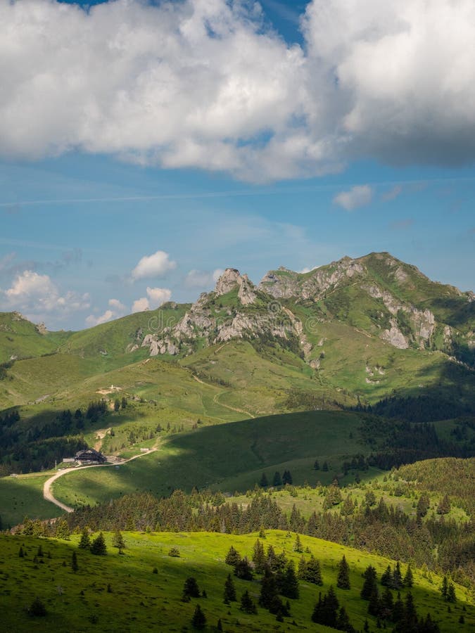 Scenic Vertical View of Ciucas Peak Under a Blue Sky Surrounded by ...