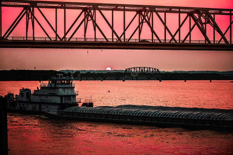 Scenic View of a Barge Passing Under a Bridge Over Ohio River at Sunset ...