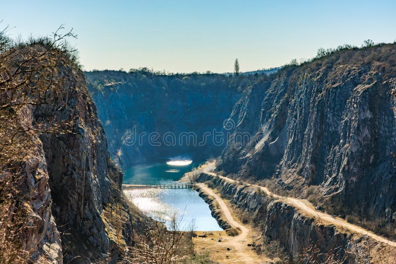 Scenic View of Deep Rocky Canyon with Clear Blue Water and Winding Path ...