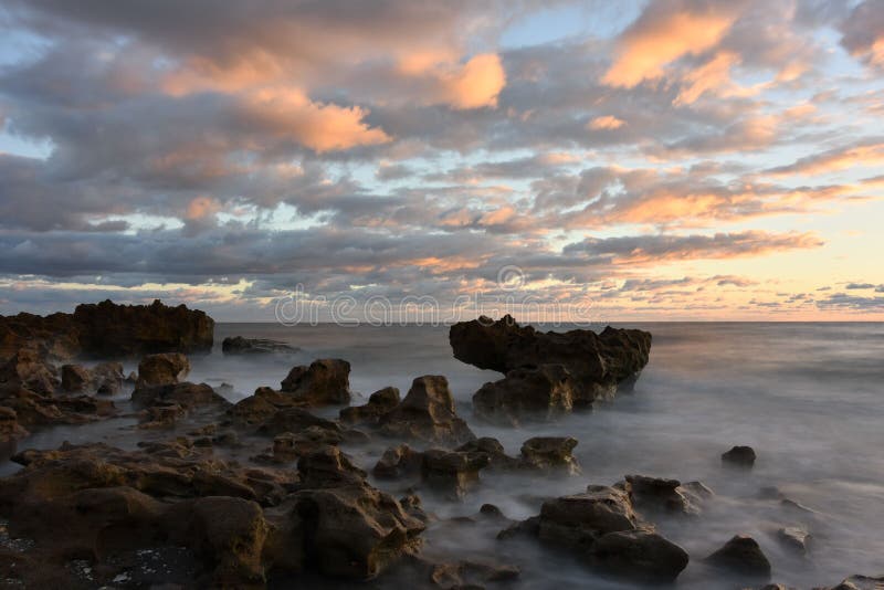 Scenic View of a Dramatic Sunset Over Coral Cove Rocks in Florida Stock ...