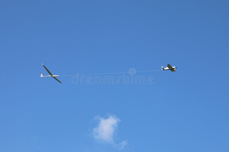 Scenic View of a Glider is Pulled Up To Altitude by a Powered Aircraft ...