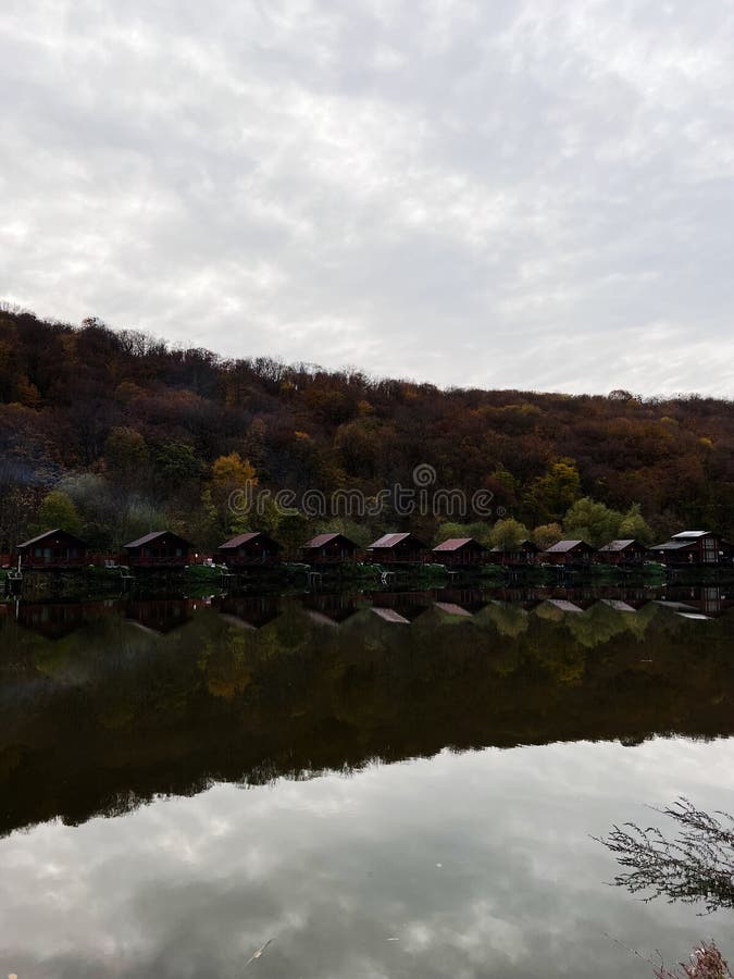 Scenic View of Lakeside Cabins with Autumn Forest Reflection Stock ...