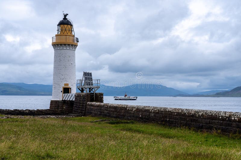 Scenic View of a Lighthouse by the Sea with a Ferry Boat in the ...