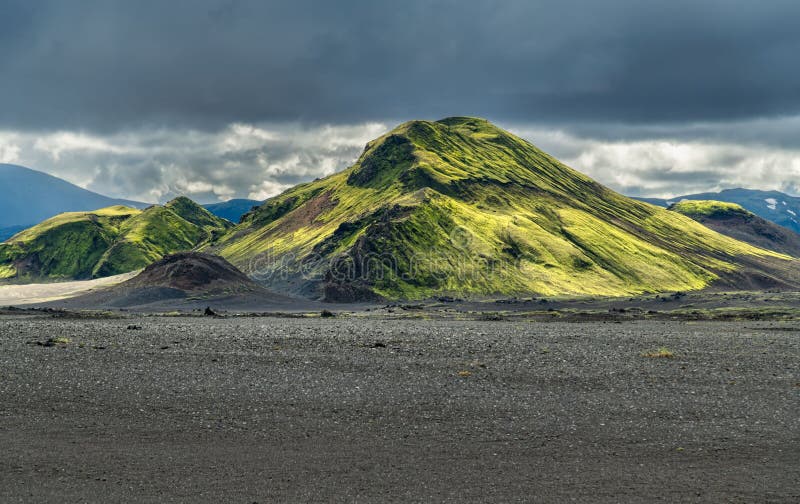 Scenic View of a Lush Green Volcanic Mountain Under a Dramatic Cloudy ...