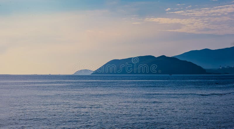 Scenic View Of Mountains Near Ocean Stock Image - Image of coast, foggy ...