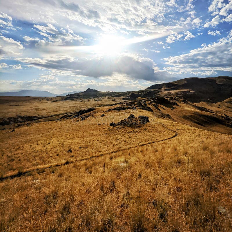 Scenic View of an Open Field with Beautiful Hills and Mountains in the ...