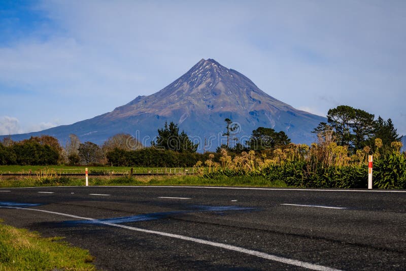 Scenic View of an Open Road Surrounded by Greenery with Taranaki ...