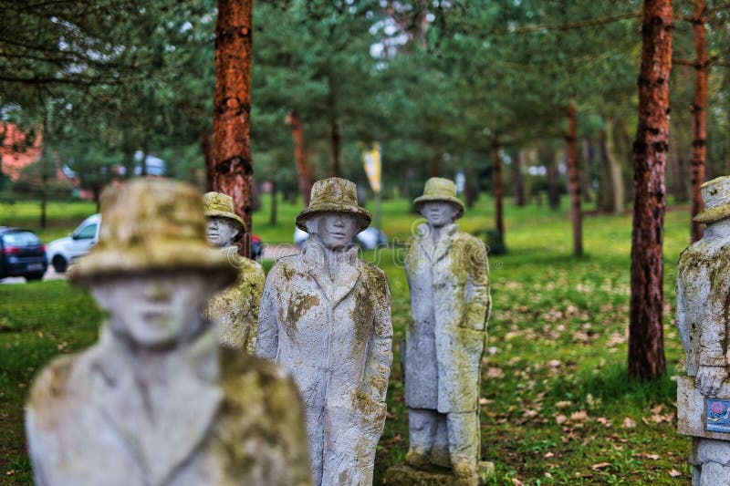 Several Statues Sitting in the Middle of a Park Surrounded by Trees ...