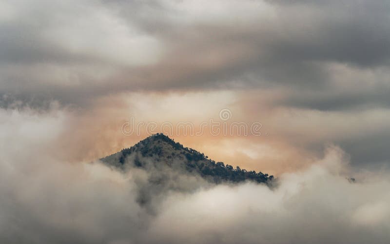 Scenic View of a Peak of a Mountain Visible Behind the Clouds Stock ...