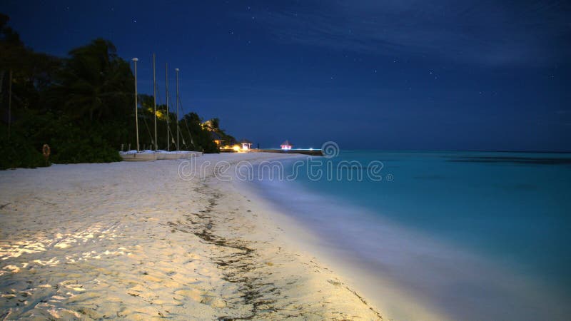 Scenic View of a Pier in a Tranquil Sandy Beach Illuminated by ...