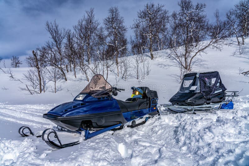 Scenic View of Snow Mobile with Sled Standing in Deep Snow at Mountain ...