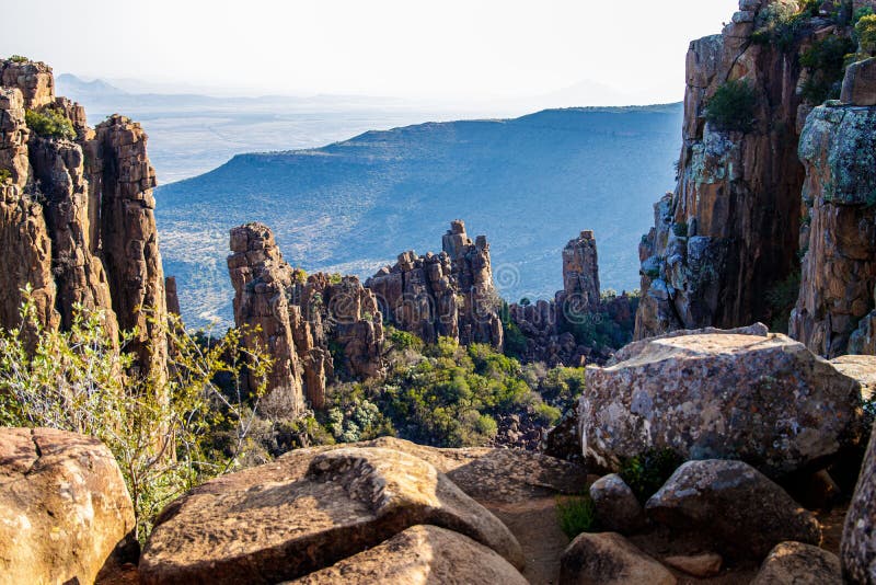 Scenic View of Stone Formations with Mountain Peaks in the Background ...