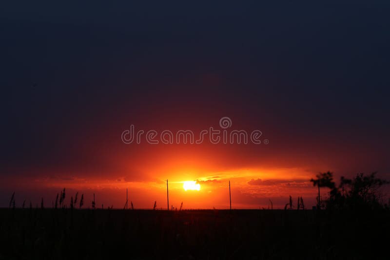 Scenic View of the Sun Setting Down Behind the Field Stock Photo ...
