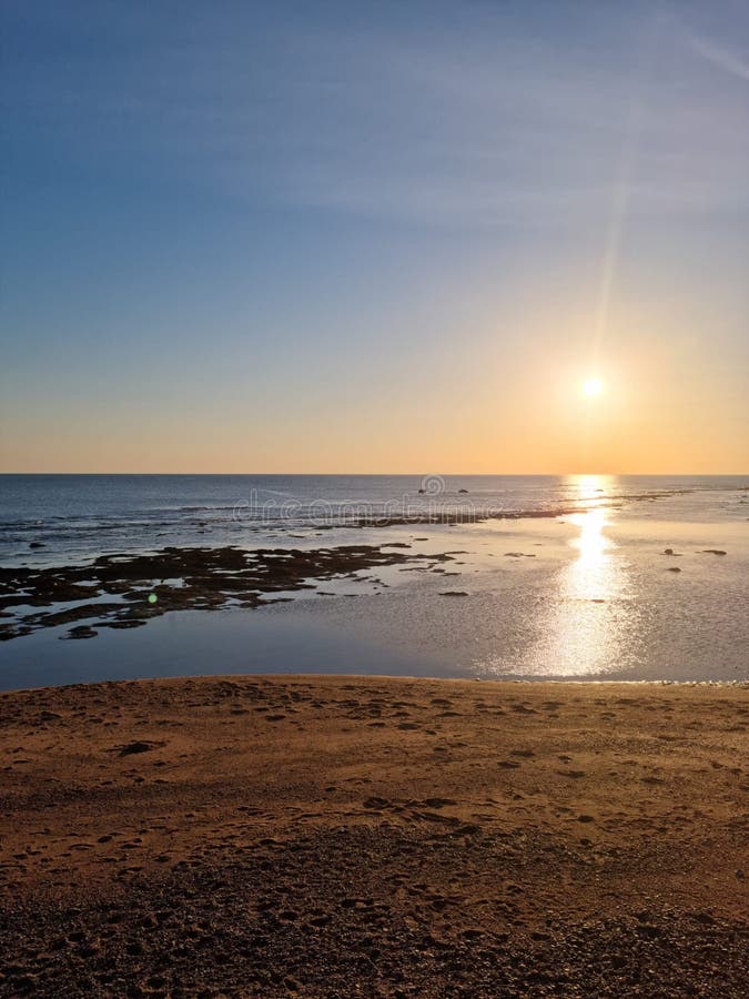 Sunrise over beach stock photo. Image of serene, beach - 245435342