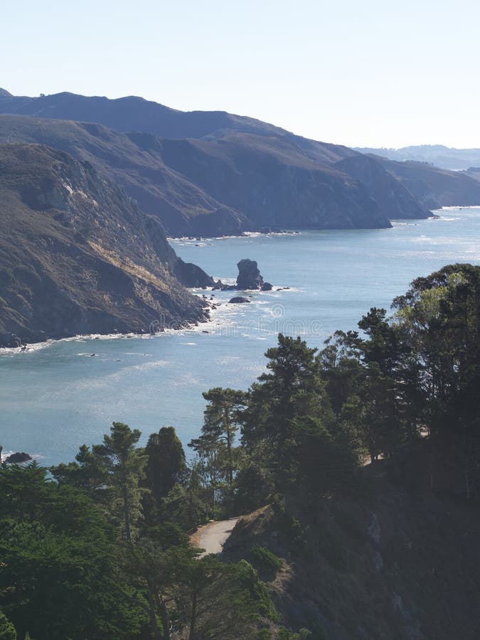 Scenic View of a Vast River Surrounded by Lush Trees and Rolling Hills ...