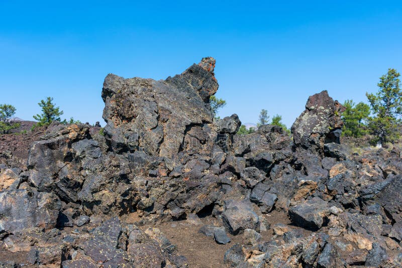 Scenic View of Volcanic Lava Rocks with Green Conifer Trees in ...