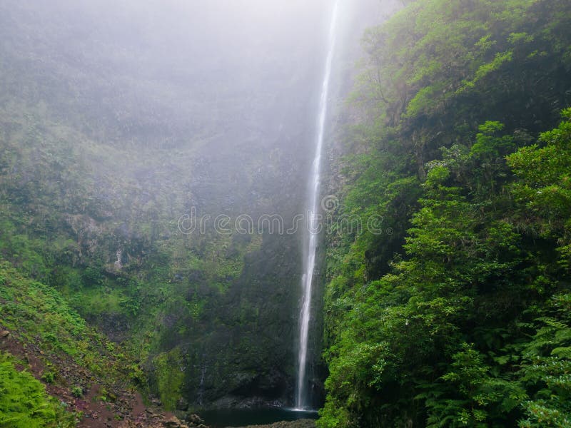 Scenic View of a Waterfall Cascading Down the Green Rocks Stock Image ...