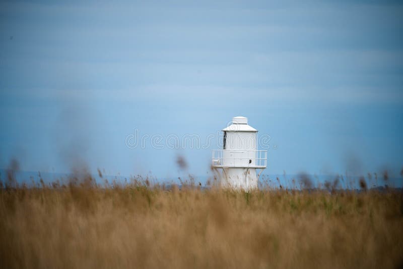 Scenic View of a White Lighthouse in a Field Stock Photo - Image of ...