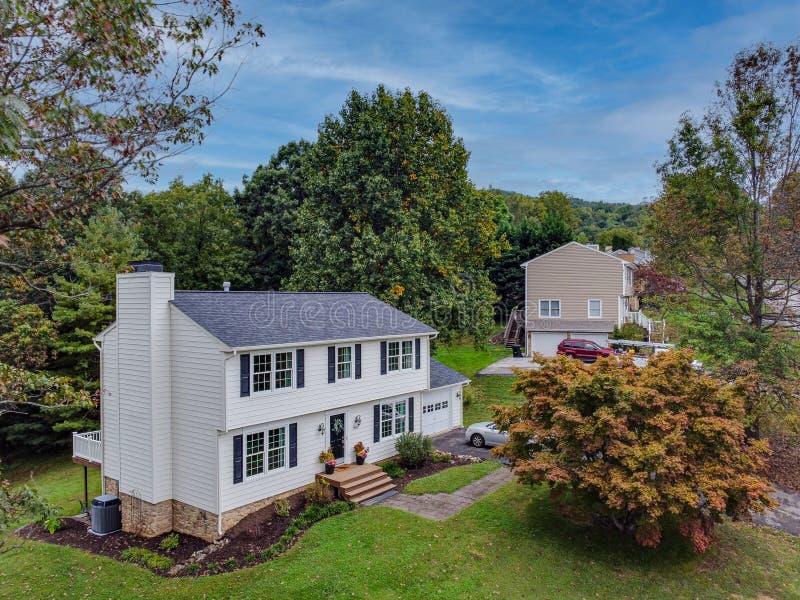 Scenic View of a White Modern House with Its Backyard Full of Greenery ...