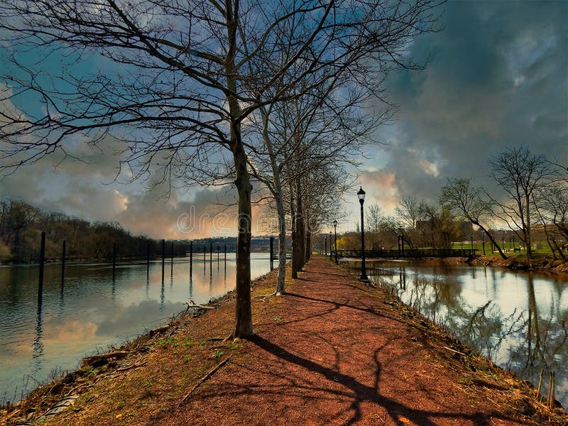 Path between Water Reflections Under the Clouds, New Jersey Stock Photo ...