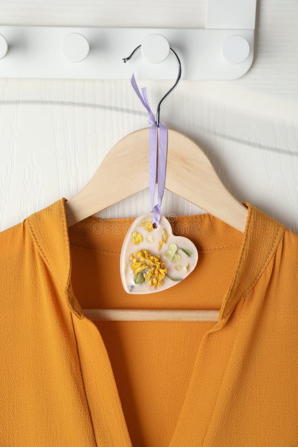 Scented Sachet with Flowers and Stylish Clothes on Hanger Stock Image ...