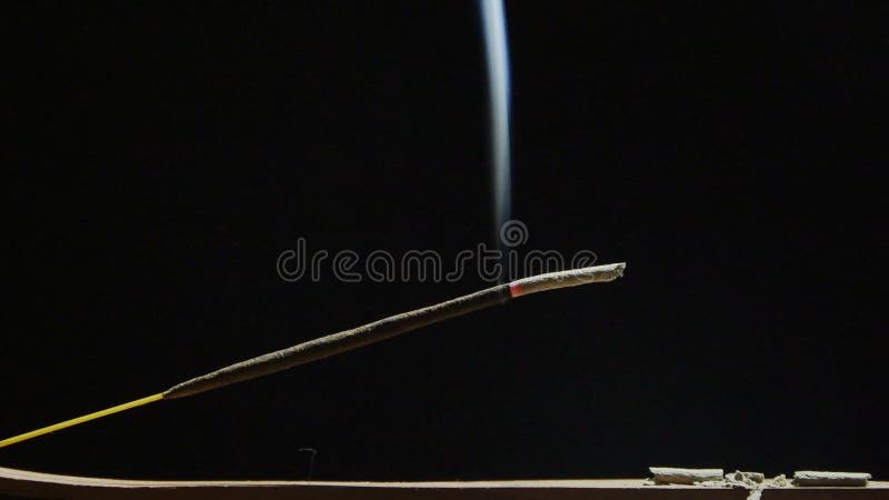 The Scented Smoke Stick Burns and Smokes on a Black Background, a ...
