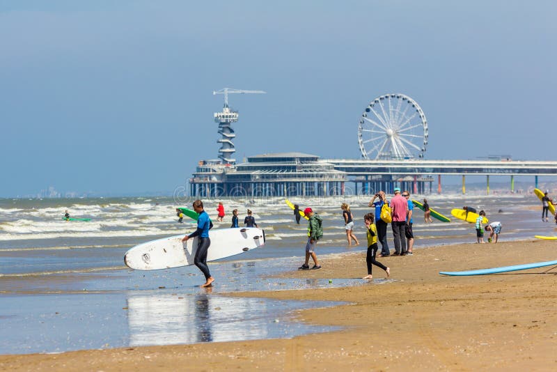 Scheveningen Pier with Beach and Young People with Surf Boards ...