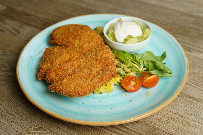 Schnitzel, Fried Chicken with Cucumber Salad and Vegetables Stock Photo ...