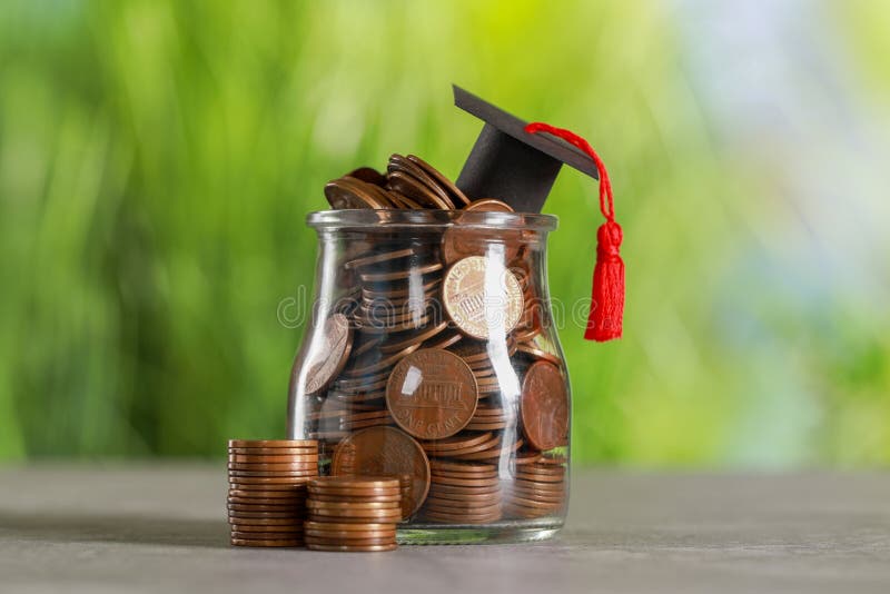 Scholarship Concept. Graduation Cap and Jar with Coins on Grey Table ...
